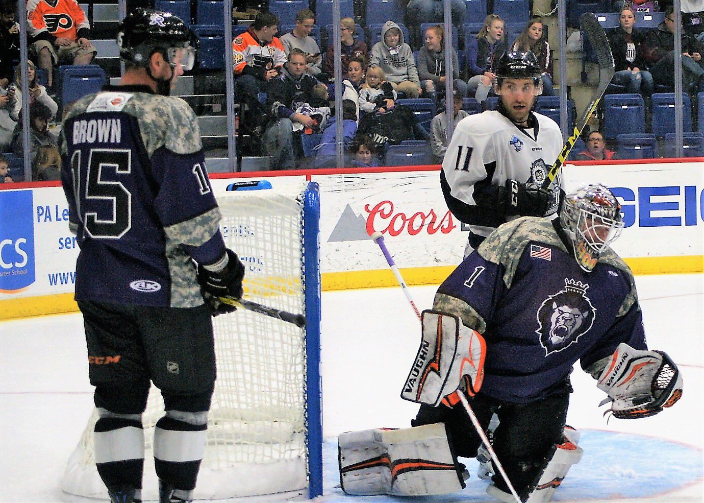 Reading's G John Muse gloves the puck as Royals Tyler Brown and ...